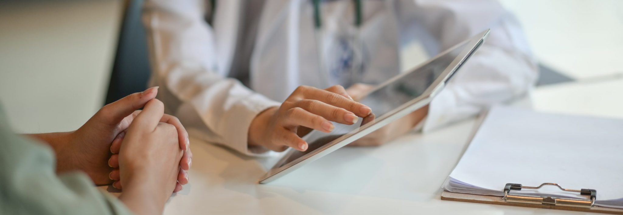 Shot of a doctor showing a patient some information on a digital tablet ...